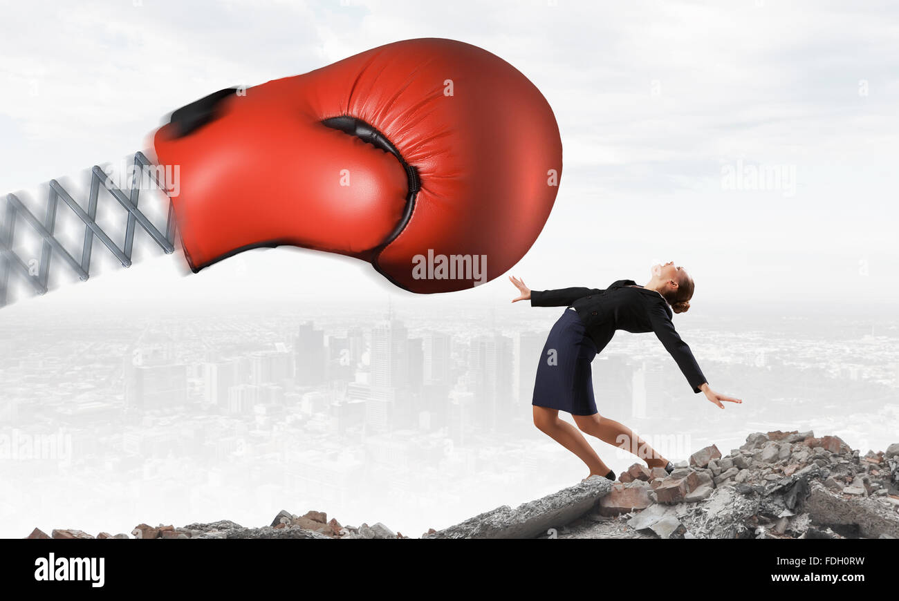 Boxing glove on spring striking businesswoman down Stock Photo - Alamy