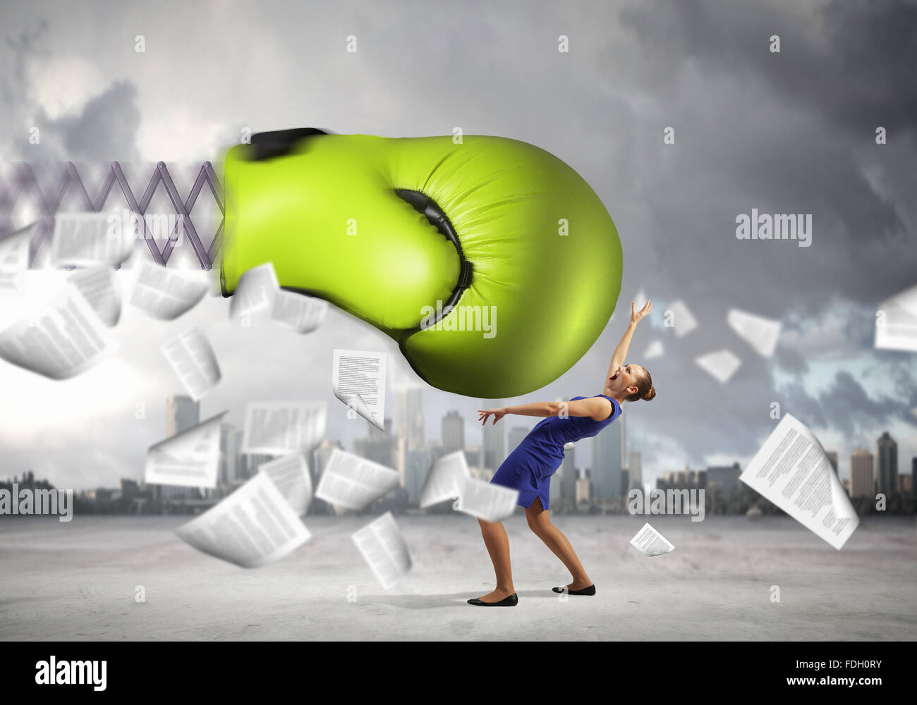 Boxing glove on spring striking businesswoman down Stock Photo - Alamy