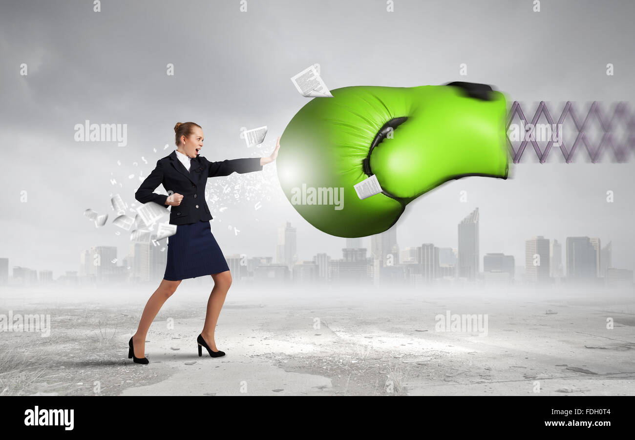 Boxing glove on spring striking businesswoman down Stock Photo - Alamy