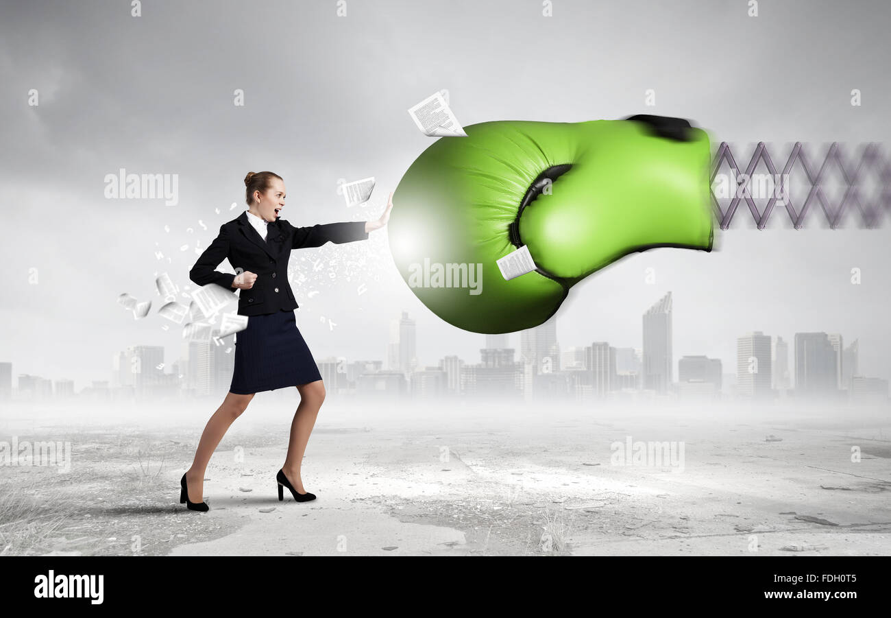 Boxing glove on spring striking businesswoman down Stock Photo - Alamy