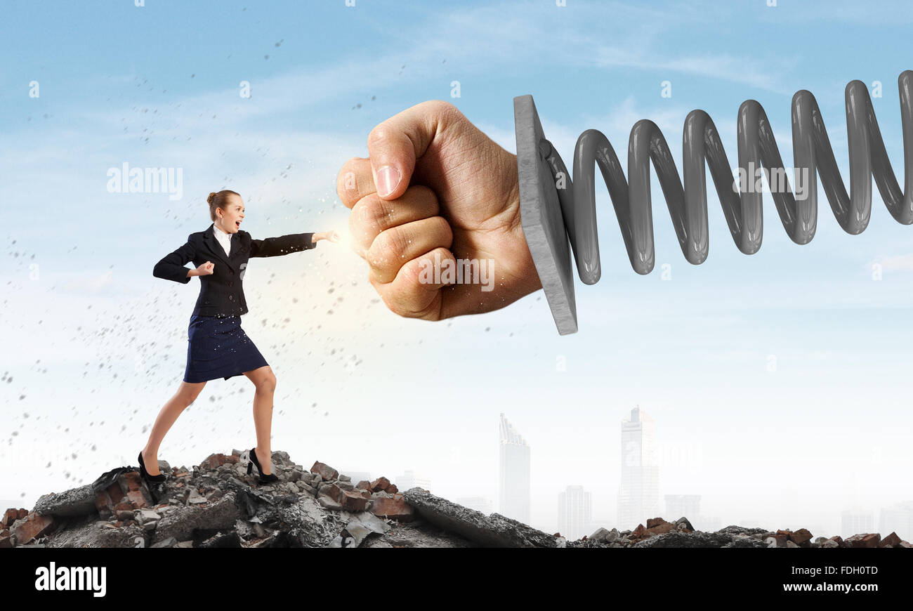 Young determined businesswoman fighting with fist on spring Stock Photo ...