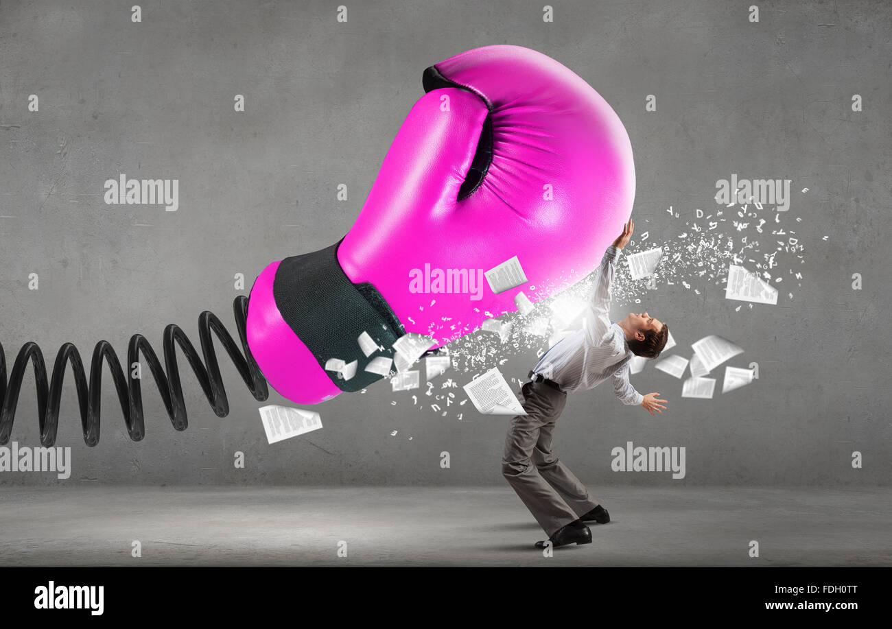Young determined businessman fighting boxing glove on spring Stock ...