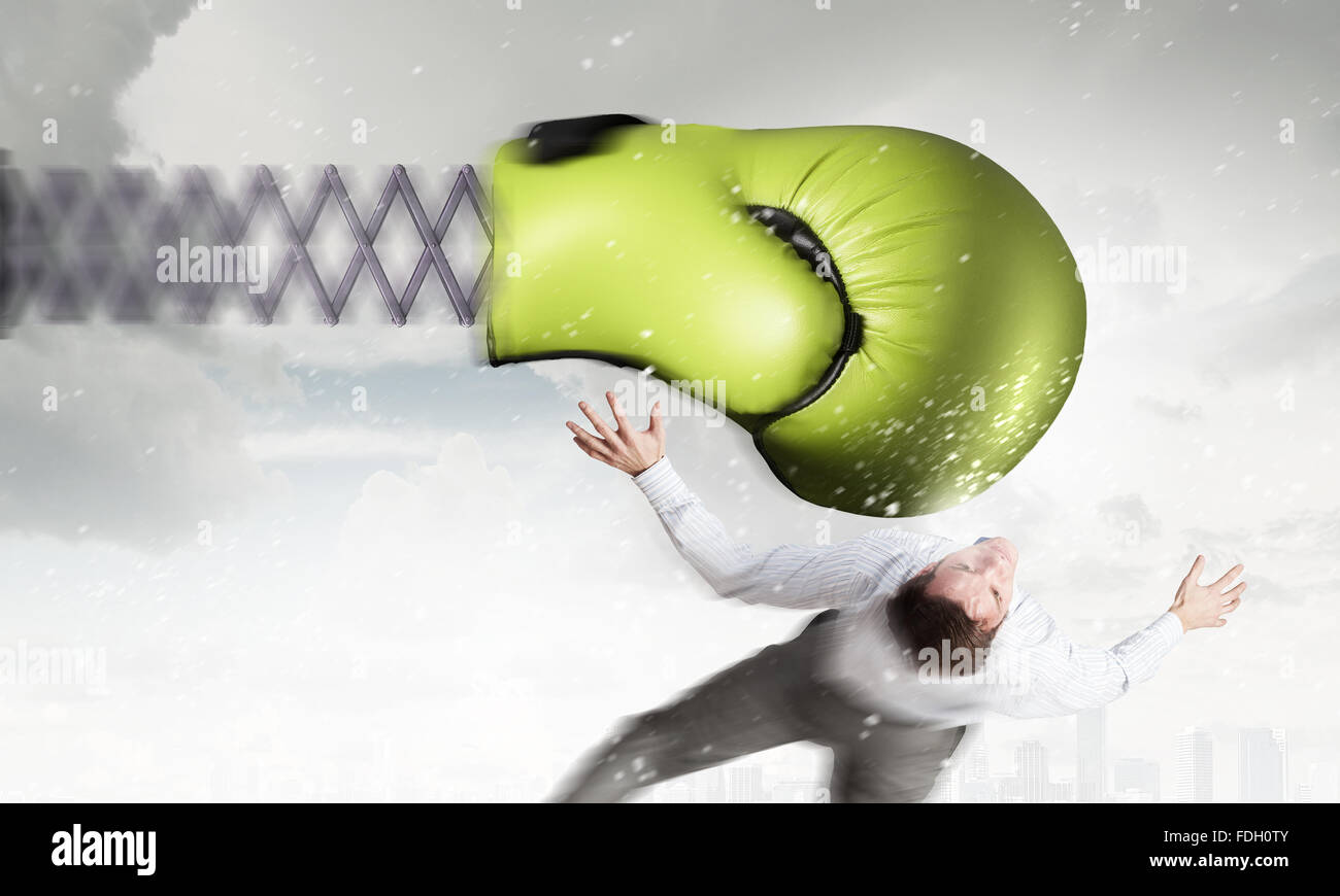 Young determined businessman fighting boxing glove on spring Stock ...