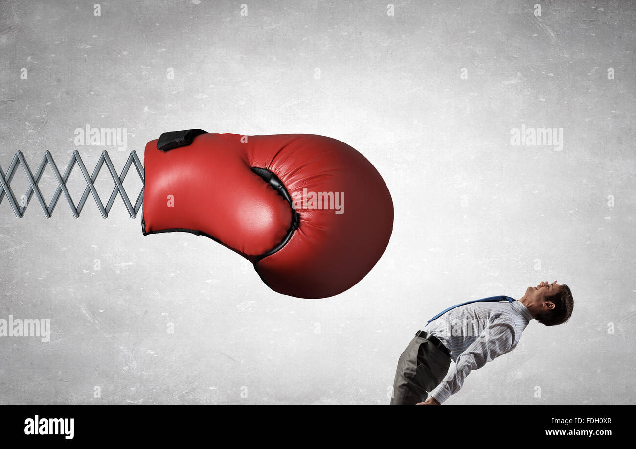 Young determined businessman fighting boxing glove on spring Stock ...