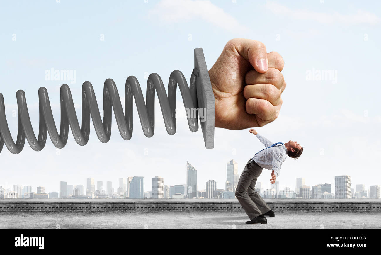 Young determined businessman fighting with human fist on spring Stock ...
