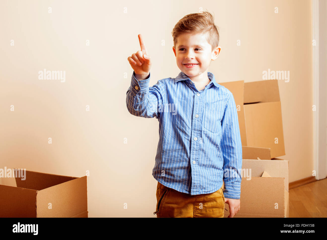 little cute boy in empty room, remoove to new house. home alone emong ...
