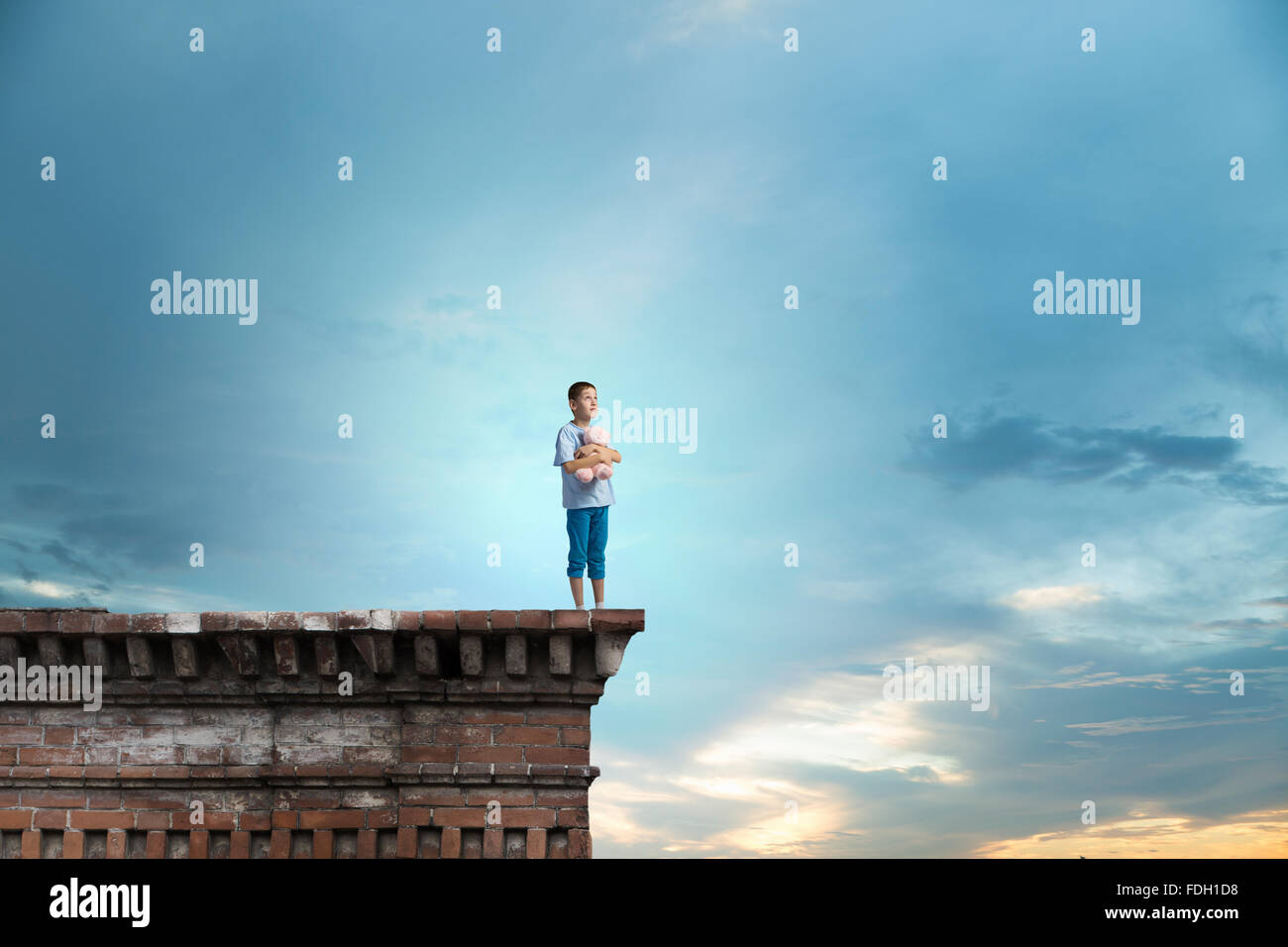 Cute little boy with toy bear on building top Stock Photo - Alamy