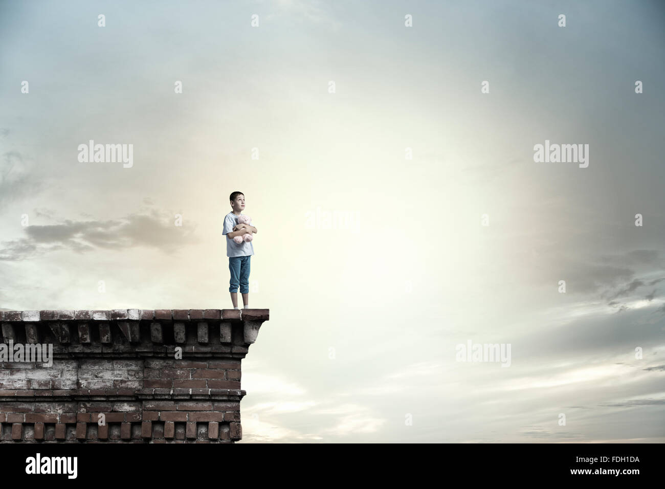 Cute little boy with toy bear on building top Stock Photo - Alamy