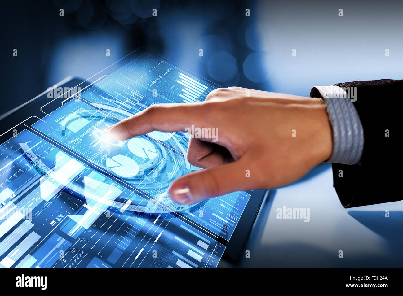 Close up of finger touching blue toned screen on tablet pc Stock Photo ...
