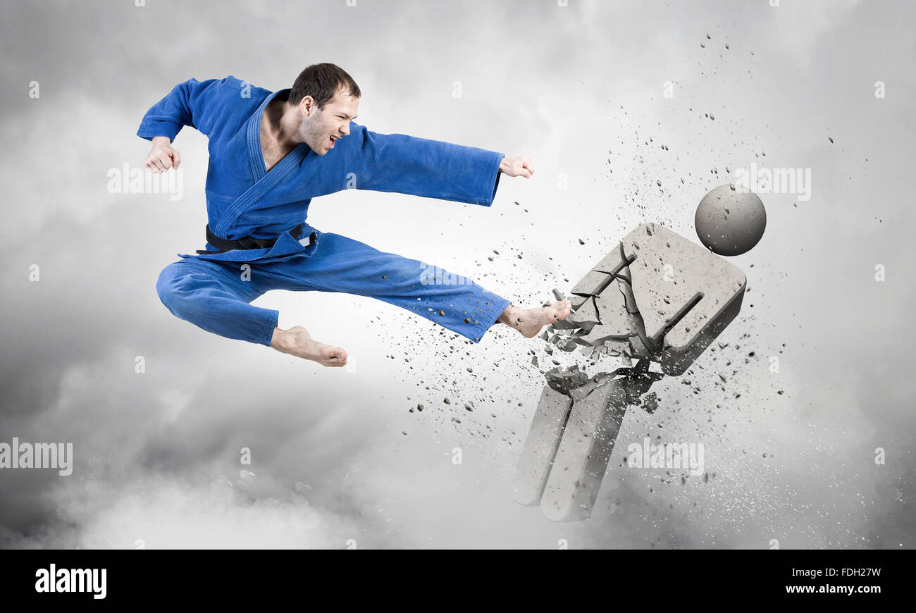 Young determined karate man breaking with leg concrete figure Stock ...