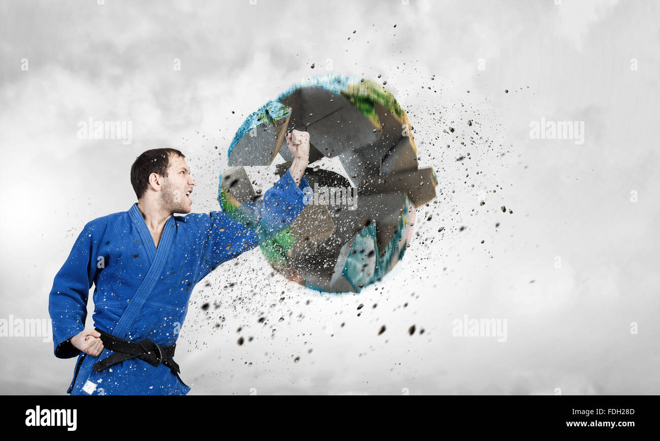 Young determined karate man breaking with leg concrete Earth planet ...