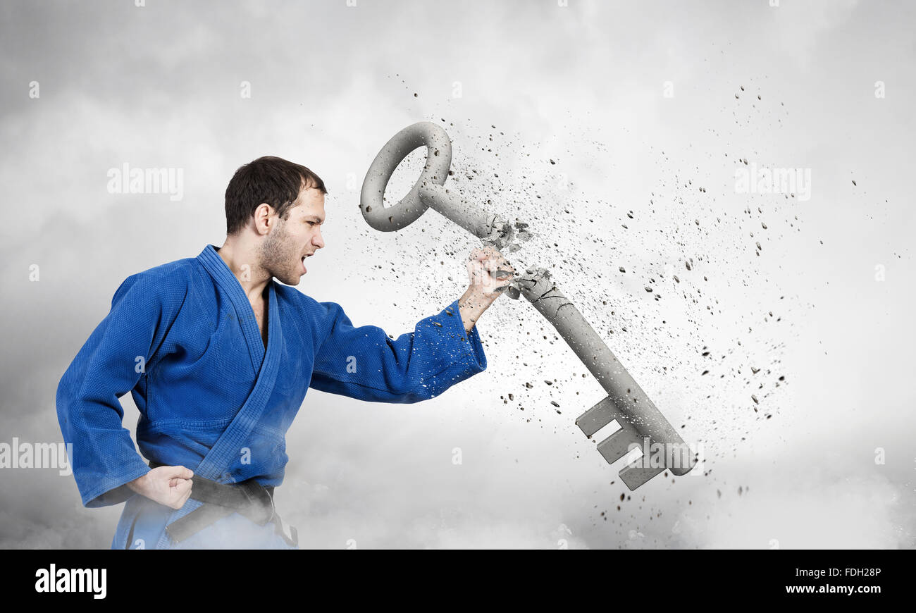 Young determined karate man breaking with anger concrete key Stock ...