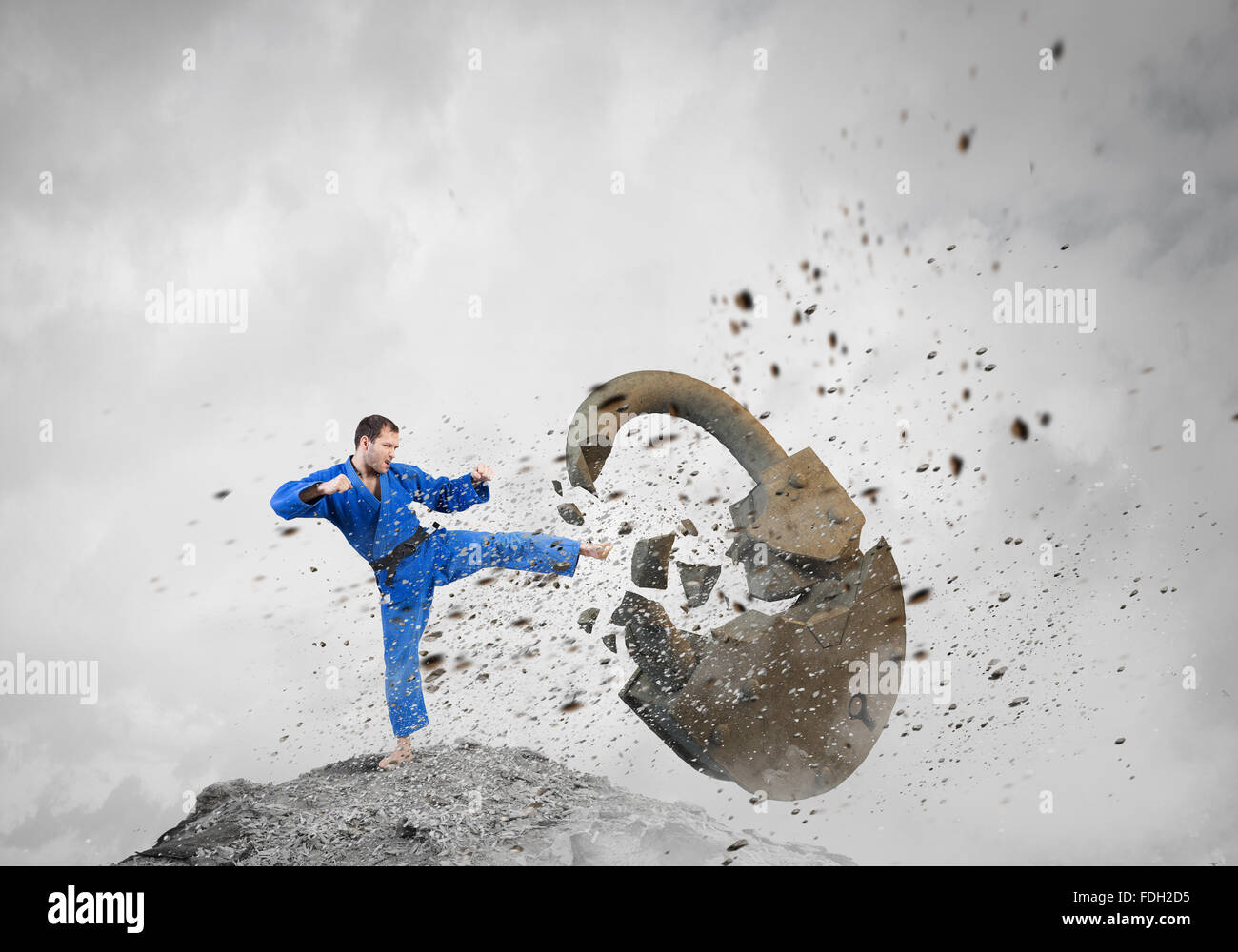 Young determined karate man breaking with anger concrete lock Stock ...