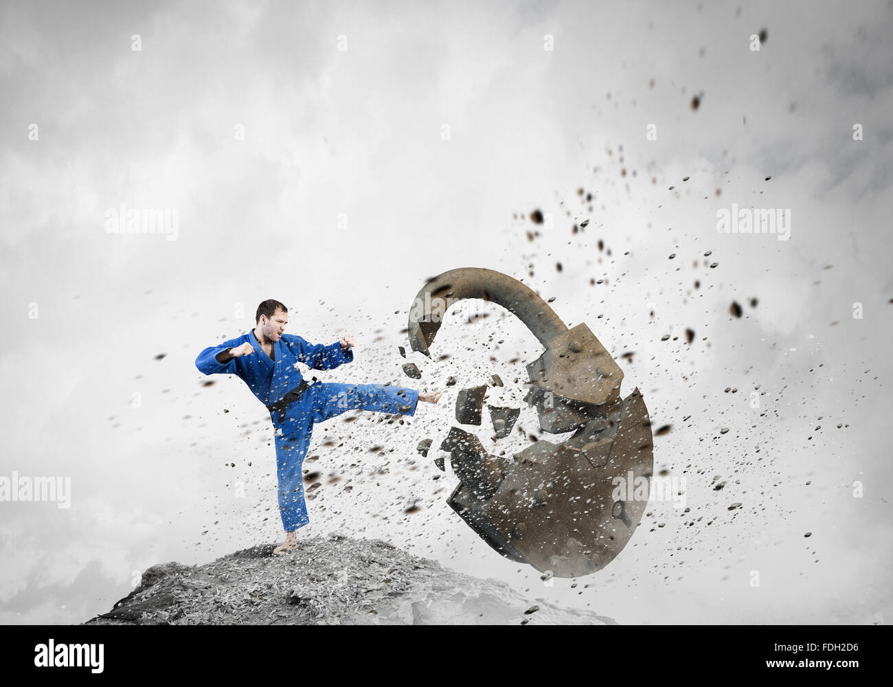 Young determined karate man breaking with anger concrete lock Stock ...