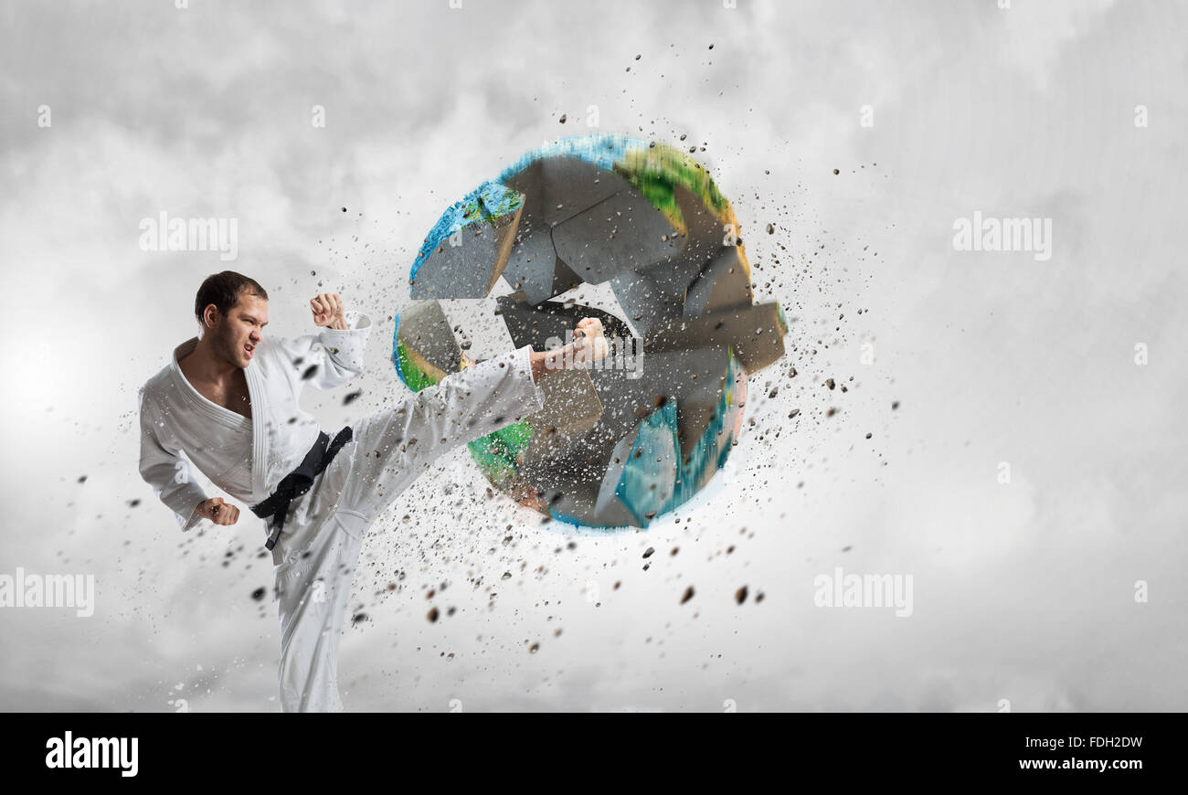 Young determined karate man breaking with leg concrete Earth planet ...