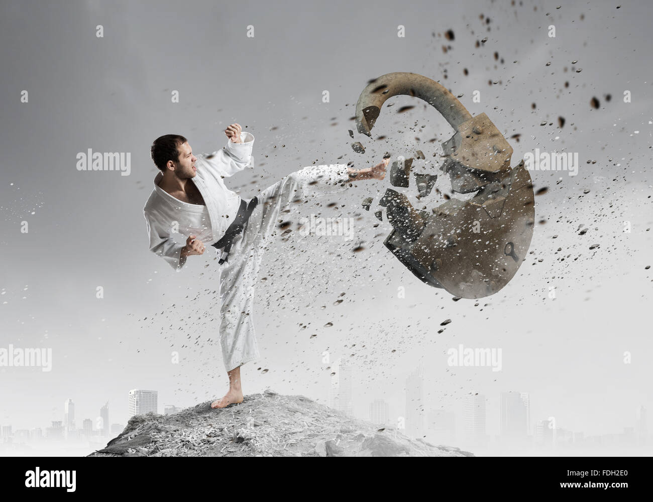 Young determined karate man breaking with anger concrete lock Stock ...