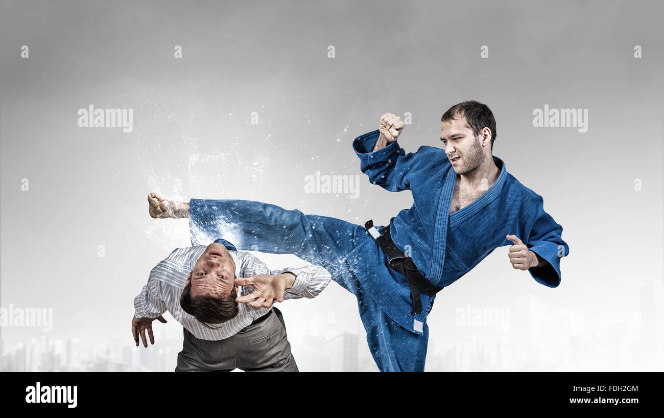 Young determined karate man fighting with businessman in suit Stock ...