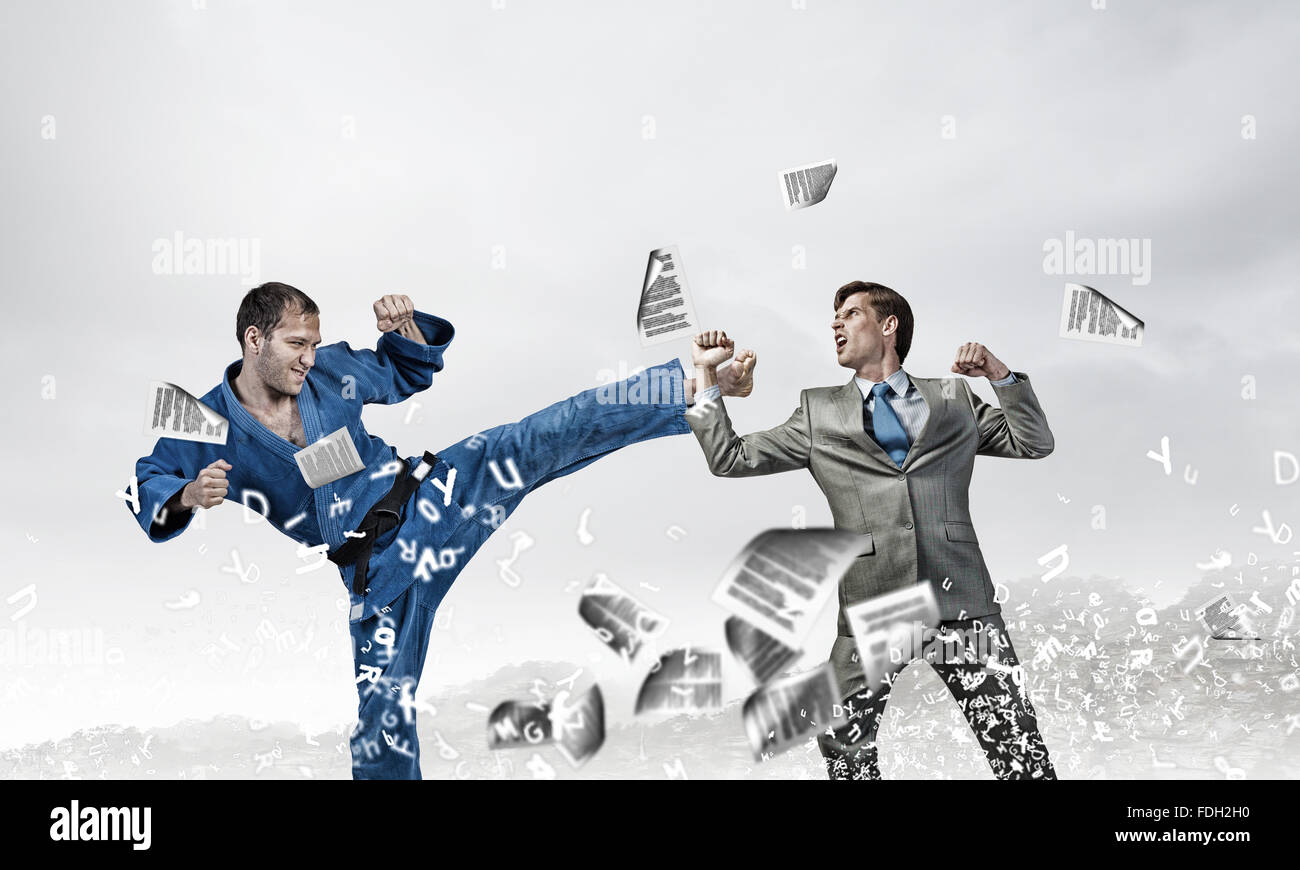 Young determined karate man fighting with businessman in suit Stock ...