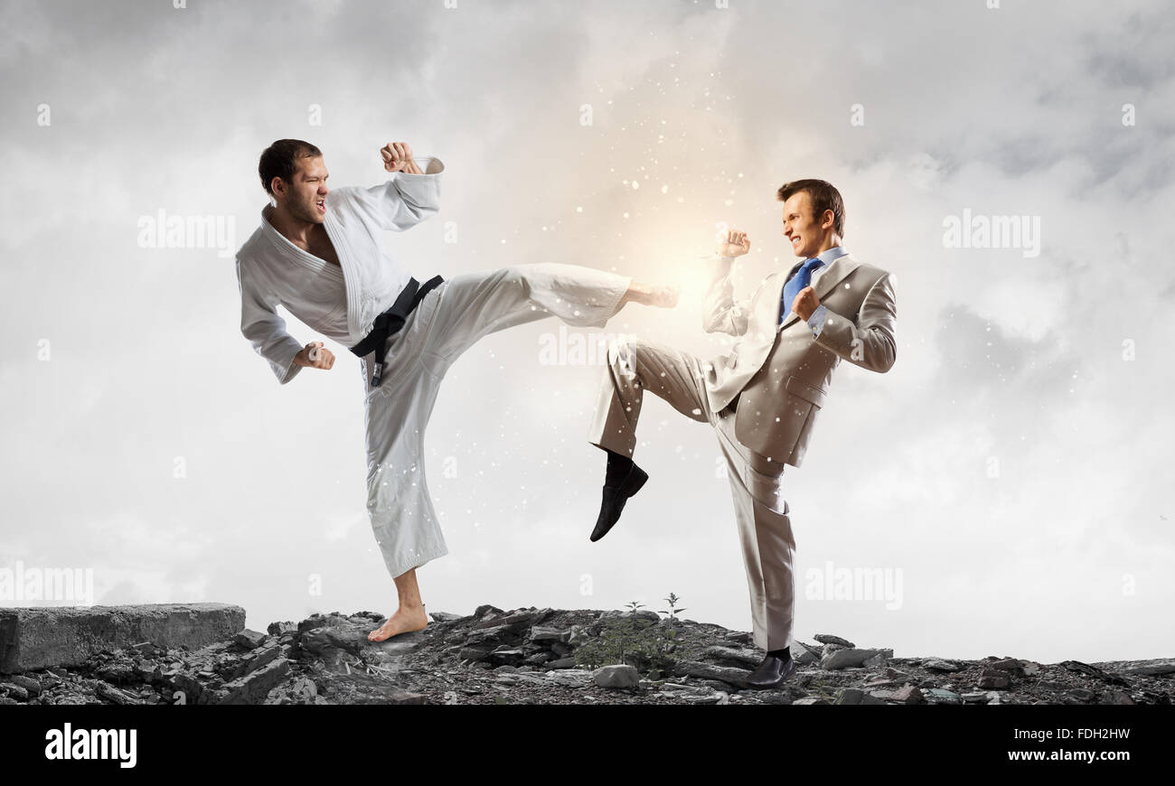 Young determined karate man fighting with businessman in suit Stock ...
