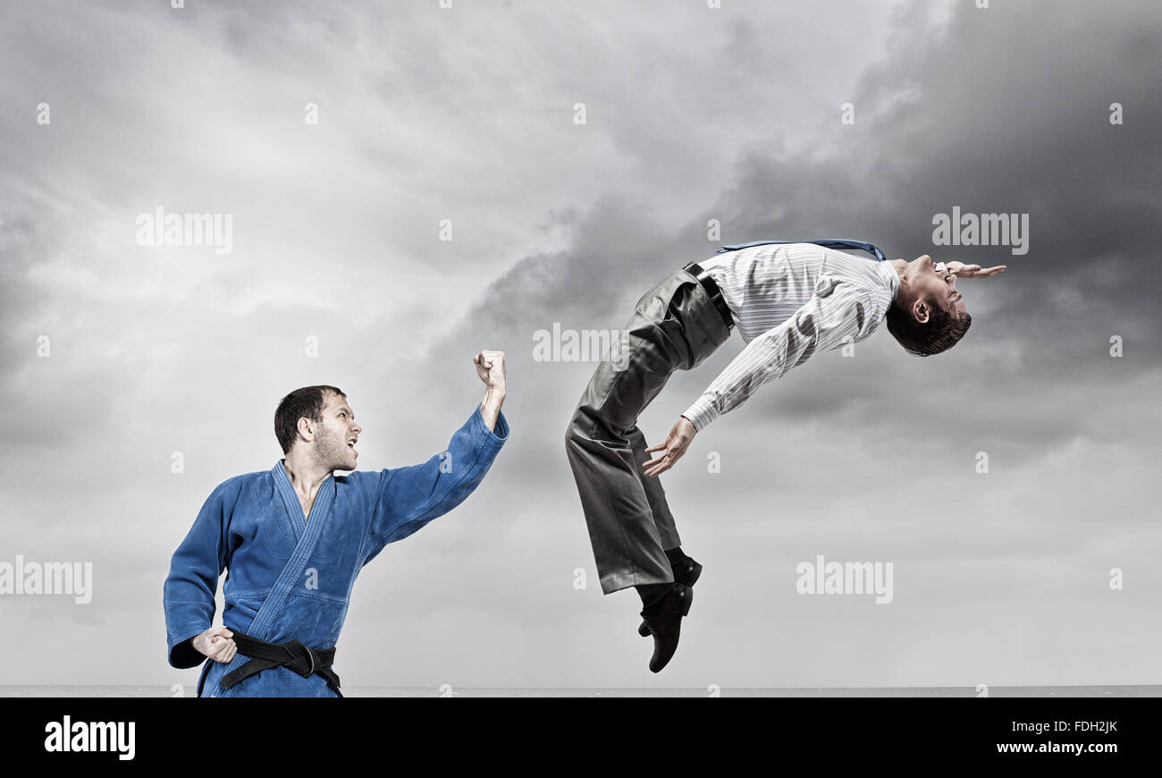 Young determined karate man fighting with businessman in suit Stock ...