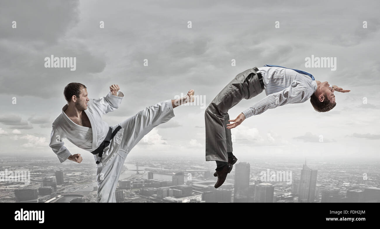 Young determined karate man fighting with businessman in suit Stock ...