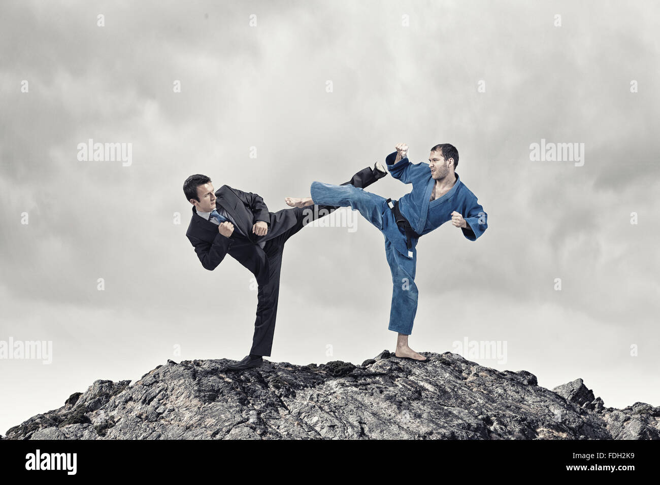 Young determined karate man fighting with businessman in suit Stock ...