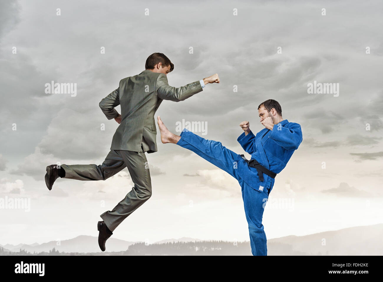 Young determined karate man fighting with businessman in suit Stock ...