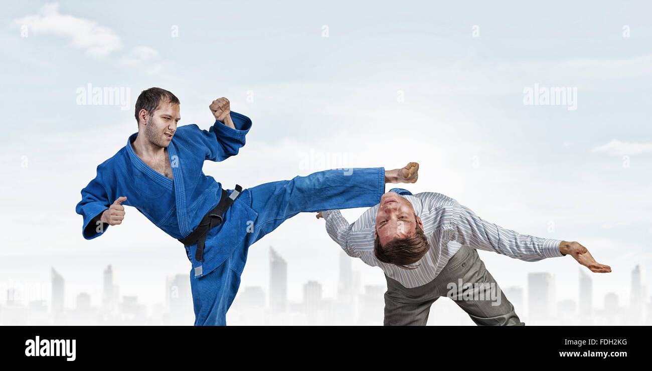 Young determined karate man fighting with businessman in suit Stock ...