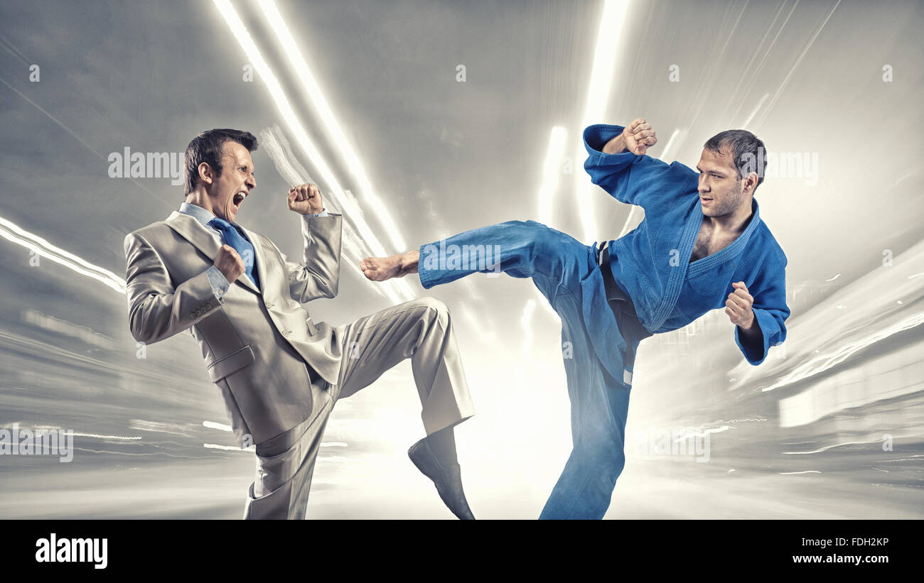 Young determined karate man fighting with businessman in suit Stock ...