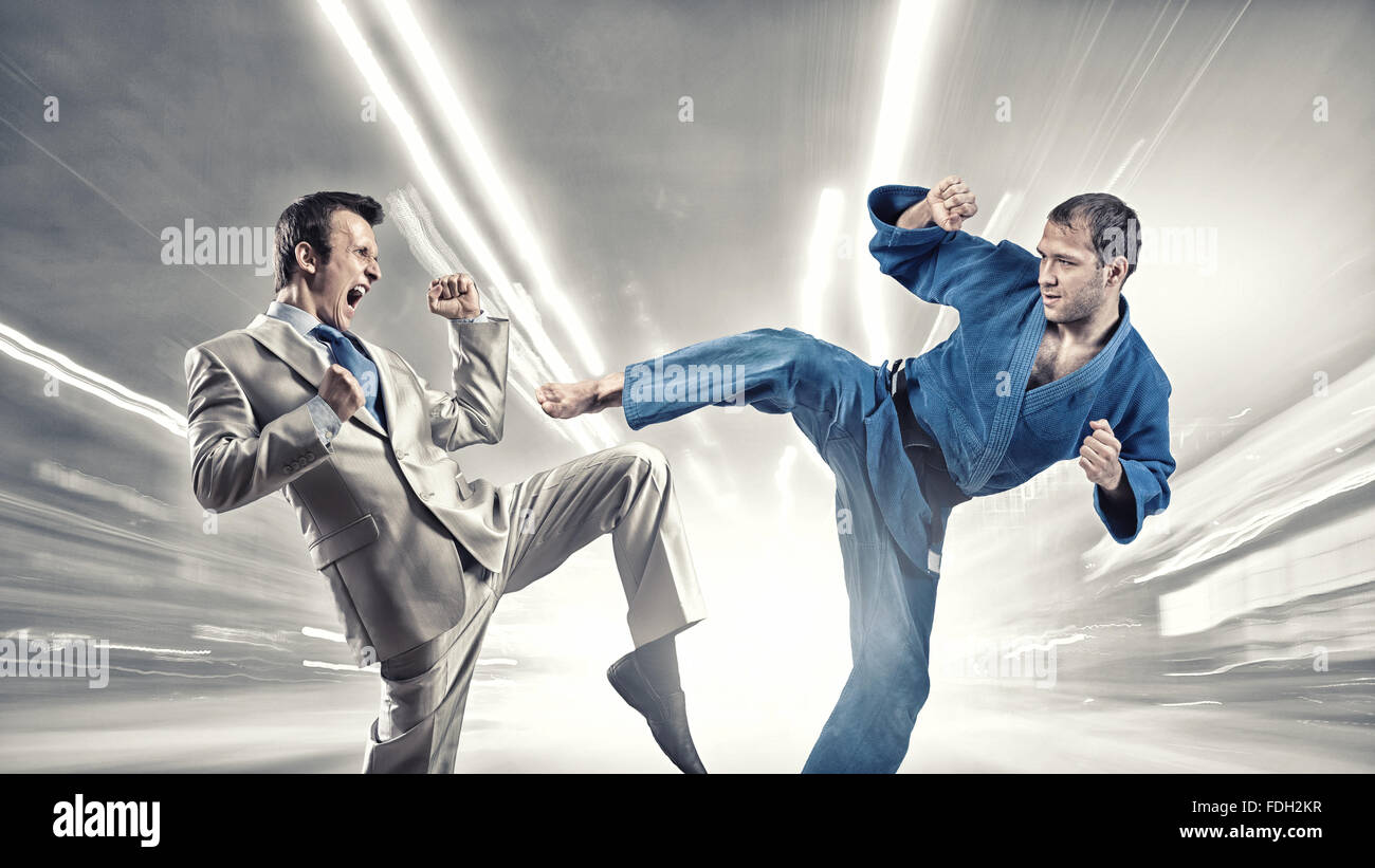 Young determined karate man fighting with businessman in suit Stock ...