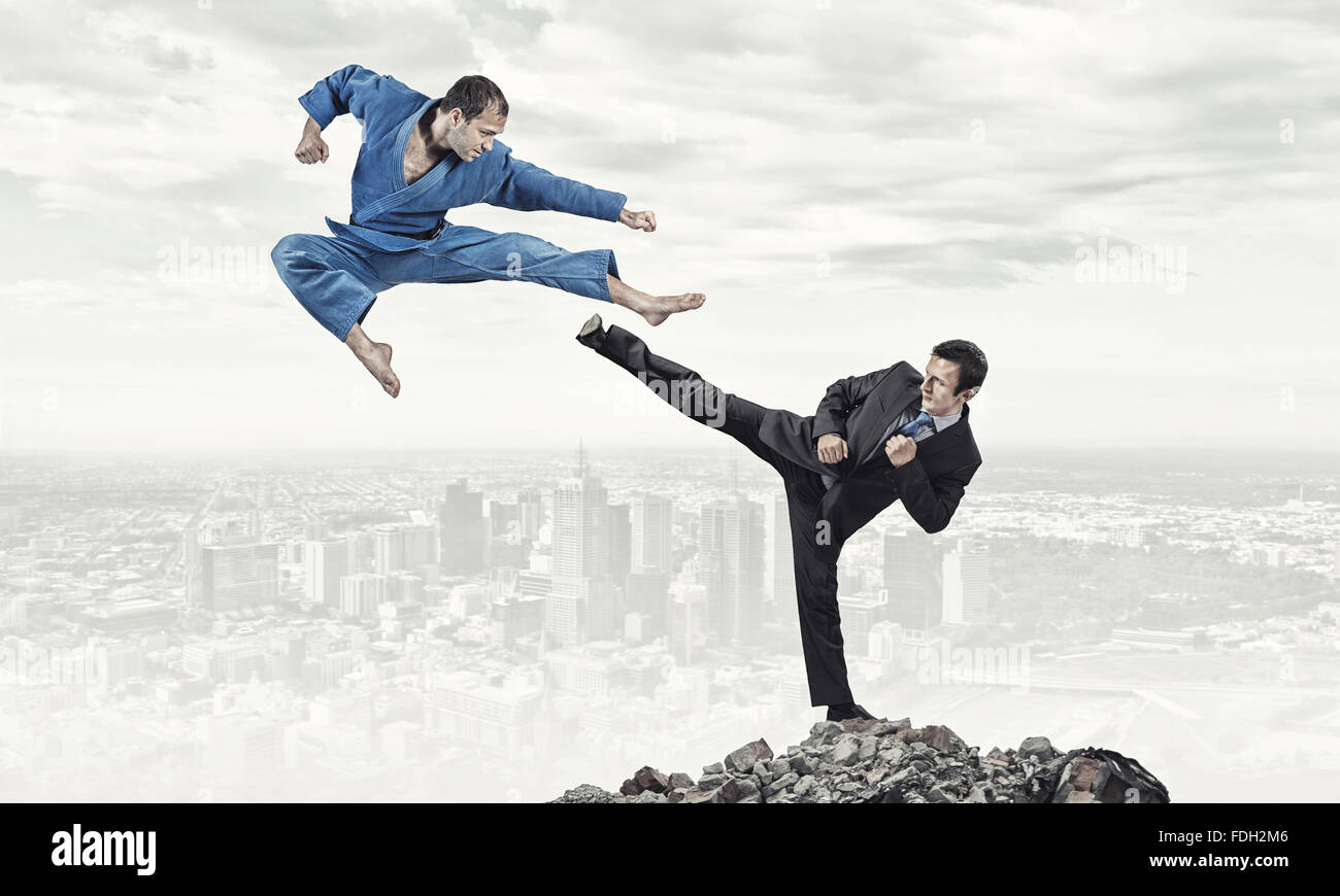 Young determined karate man fighting with businessman in suit Stock ...