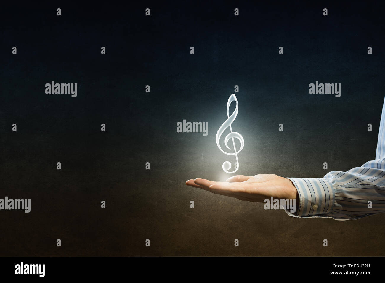 Hand of man hold music note icon in palm Stock Photo - Alamy