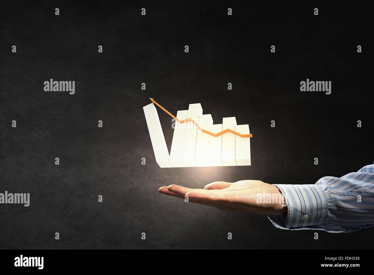 Hand of businessman on dark background showing glowing business growth ...