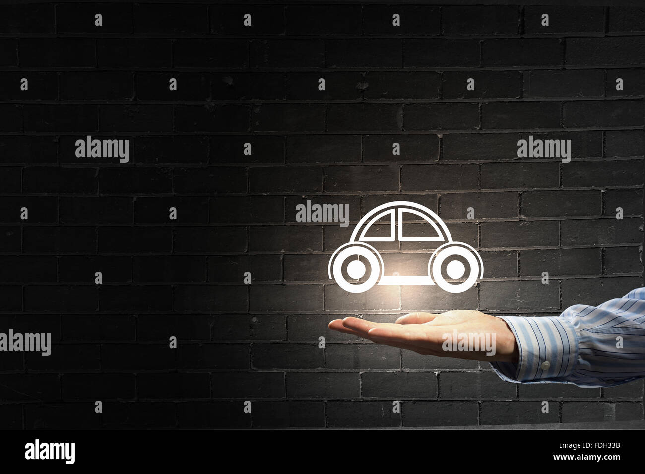 Male hand holding car icon on dark background Stock Photo - Alamy