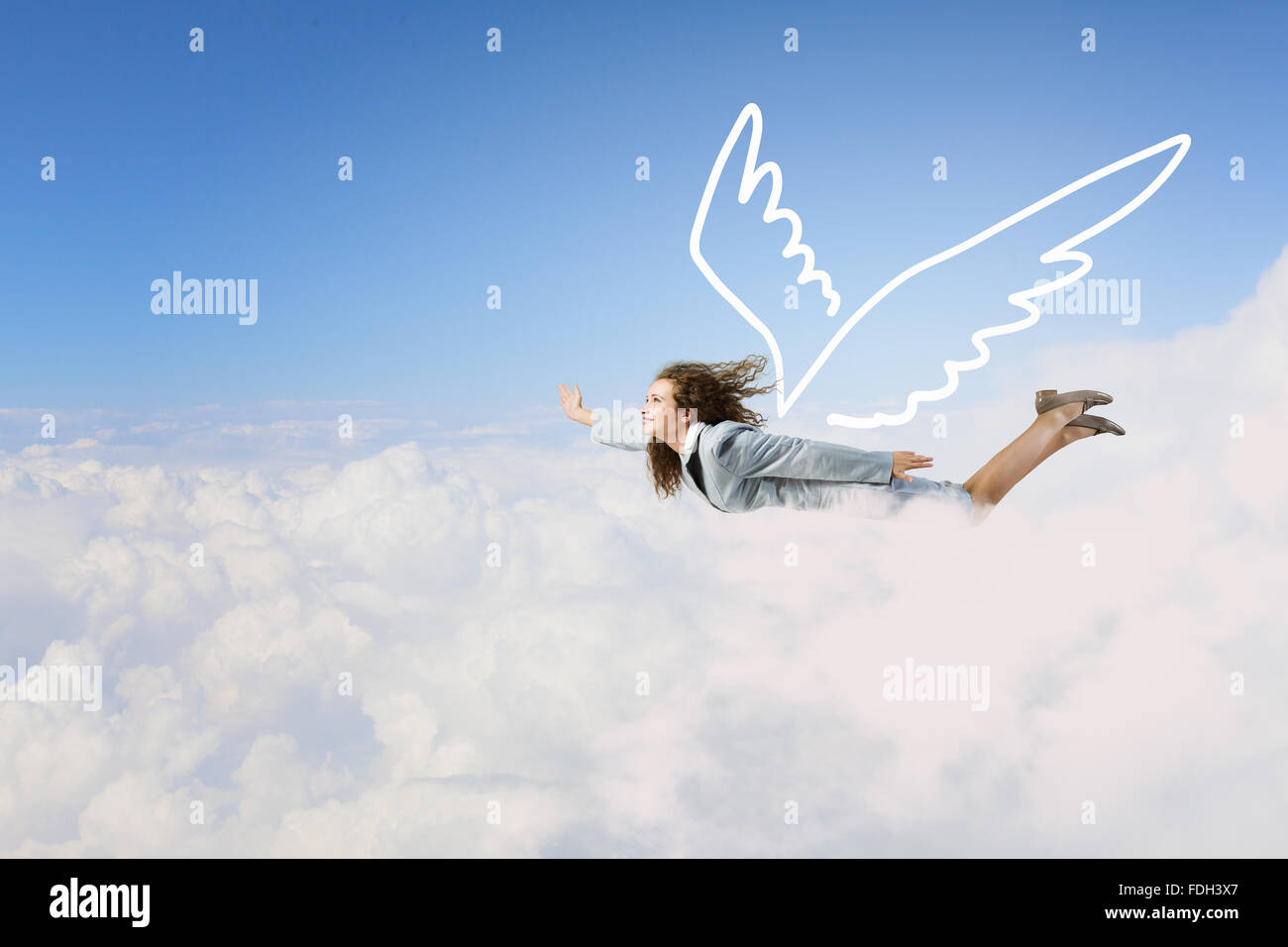 Young businesswoman with drawn wings flying high in sky Stock Photo - Alamy