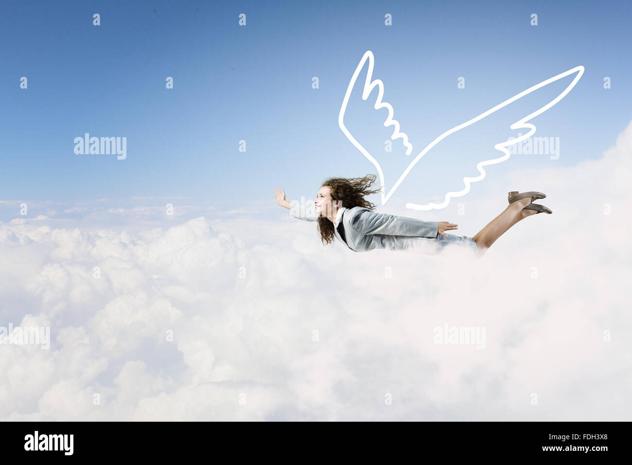 Young businesswoman with drawn wings flying high in sky Stock Photo - Alamy