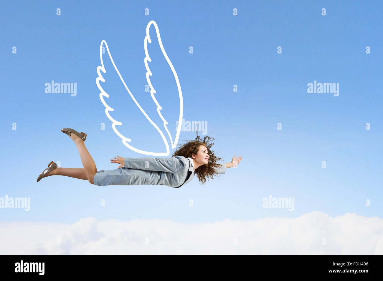 Young businesswoman with drawn wings flying high in sky Stock Photo - Alamy