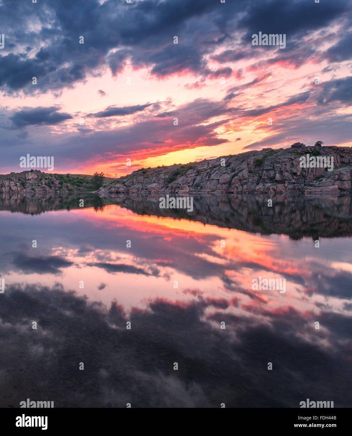 Beautiful landscape. Colorful sunset at the lake with clouds reflected ...