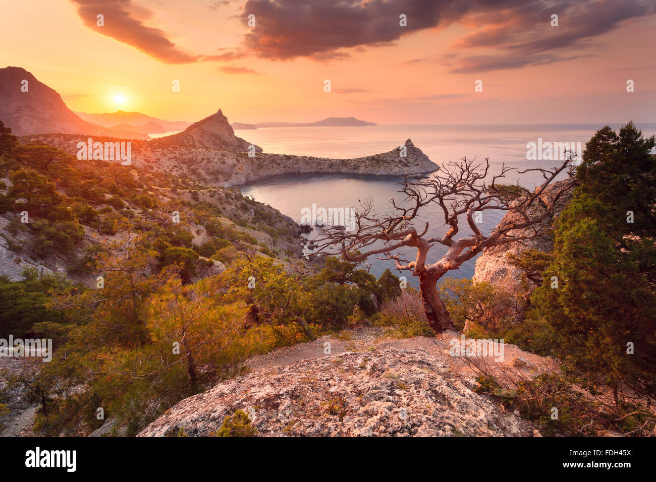 Beautiful colorful landscape. Sunrise in mountains with sea, cloudy sky ...