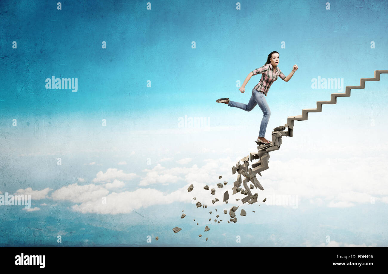 Young woman walking up collapsing staircase representing success ...