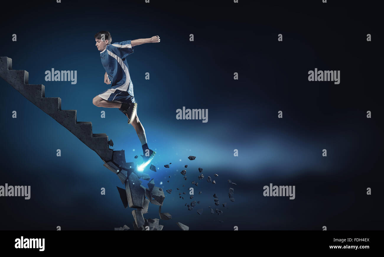 Sports active man running on stone collapsing ladder Stock Photo - Alamy
