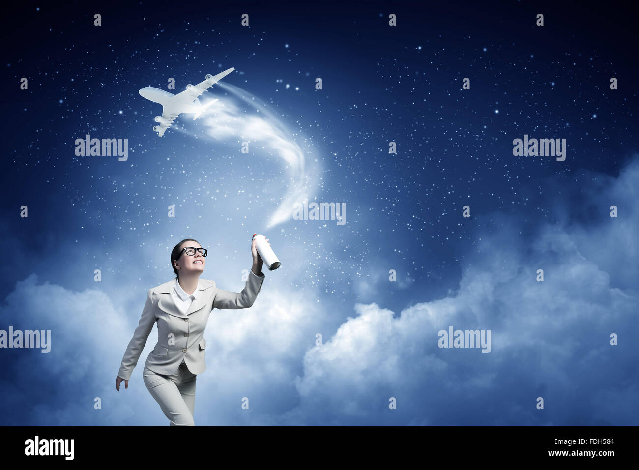 Young woman in suit and glasses spraying airplane in sky Stock Photo ...