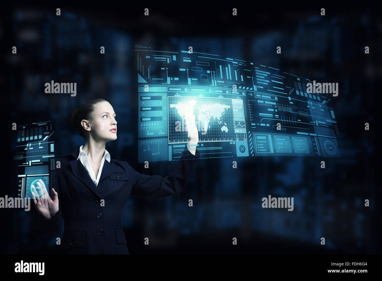 Attractive smiling businesswoman working with virtual panel interface ...