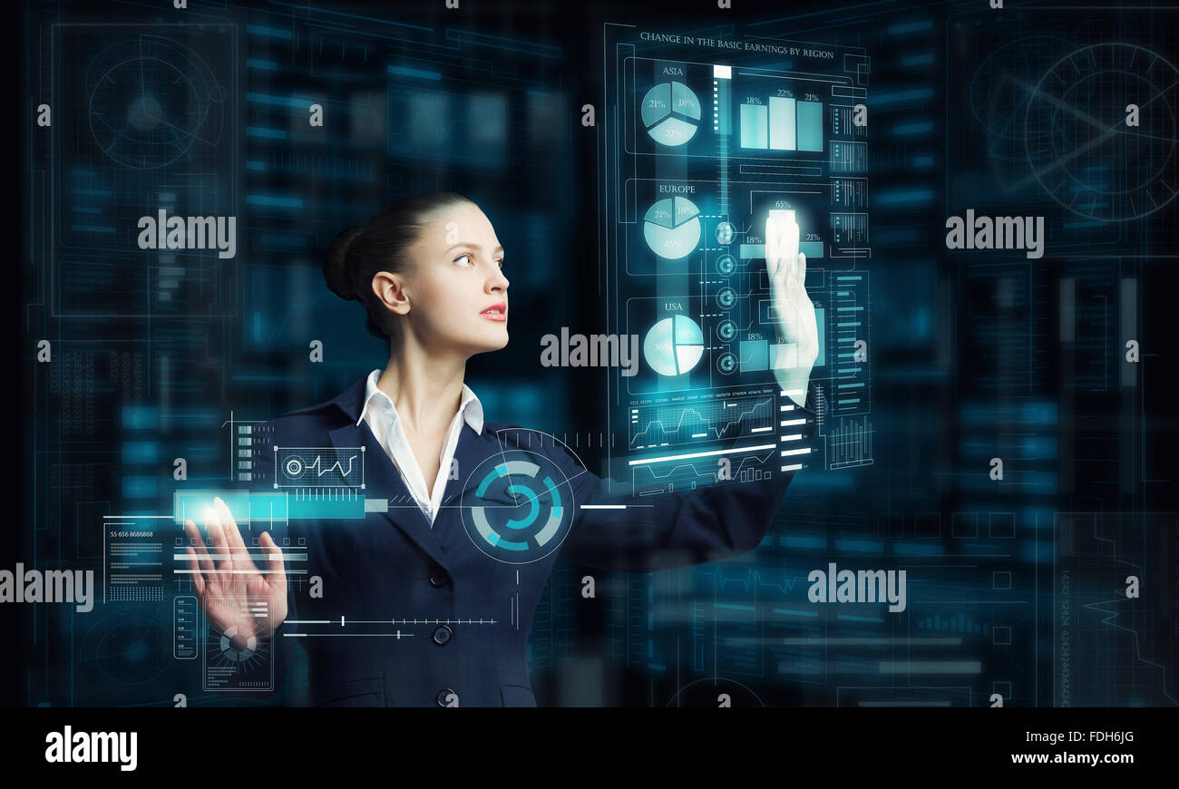 Attractive smiling businesswoman working with virtual panel interface ...