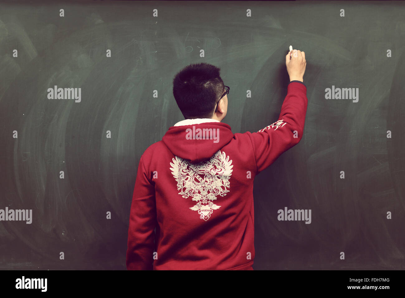 College student writing on blackboard hi-res stock photography and ...