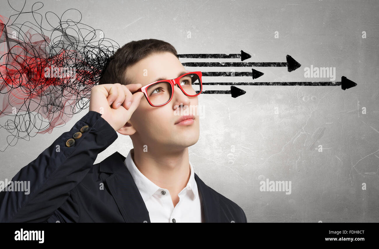 Thoughtful businessman with arrows and thoughts coming out of his head ...