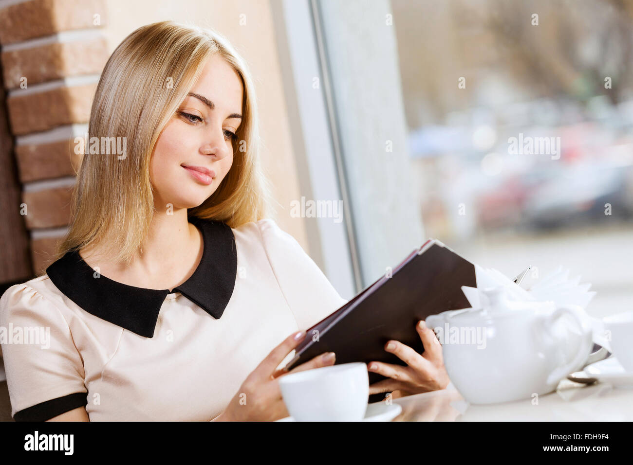 Young attractive woman making order at restaurant Stock Photo - Alamy
