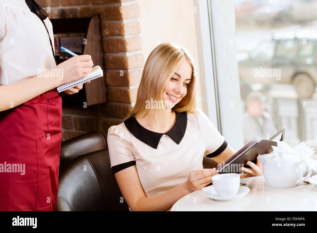 Young attractive woman making order at restaurant Stock Photo - Alamy