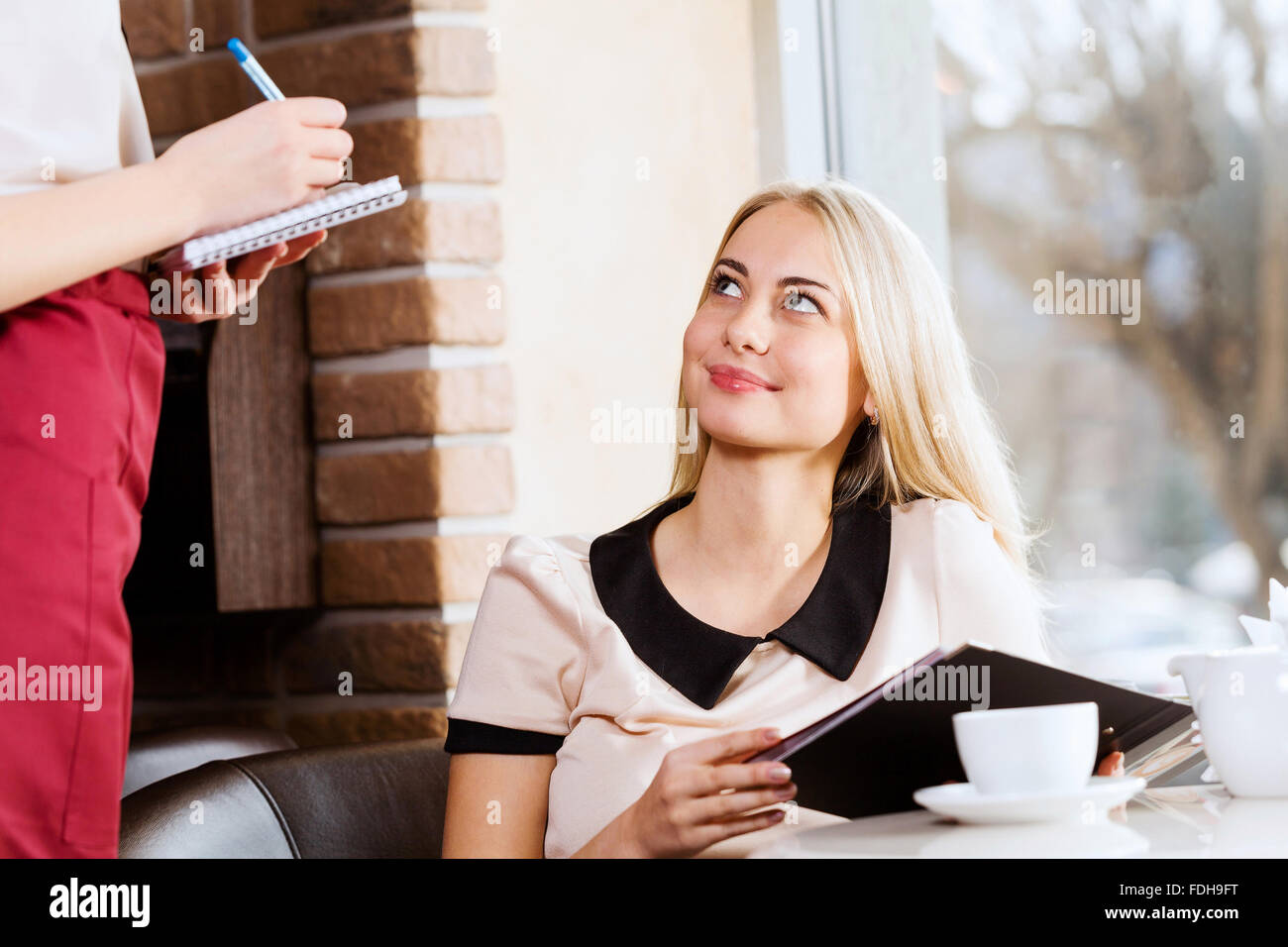 Young attractive woman making order at restaurant Stock Photo - Alamy