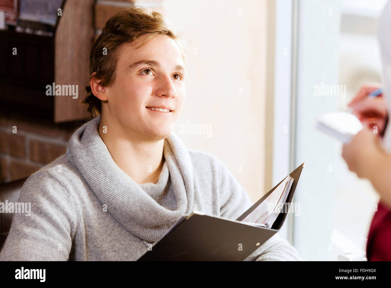 Young attractive woman making order at restaurant Stock Photo - Alamy